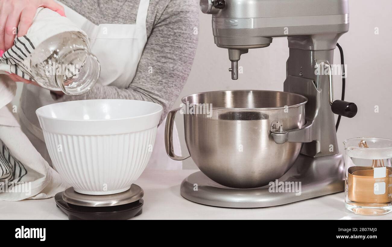 Step by step. Flat lay. Mixing royal icing in electric kitchen mixer ...