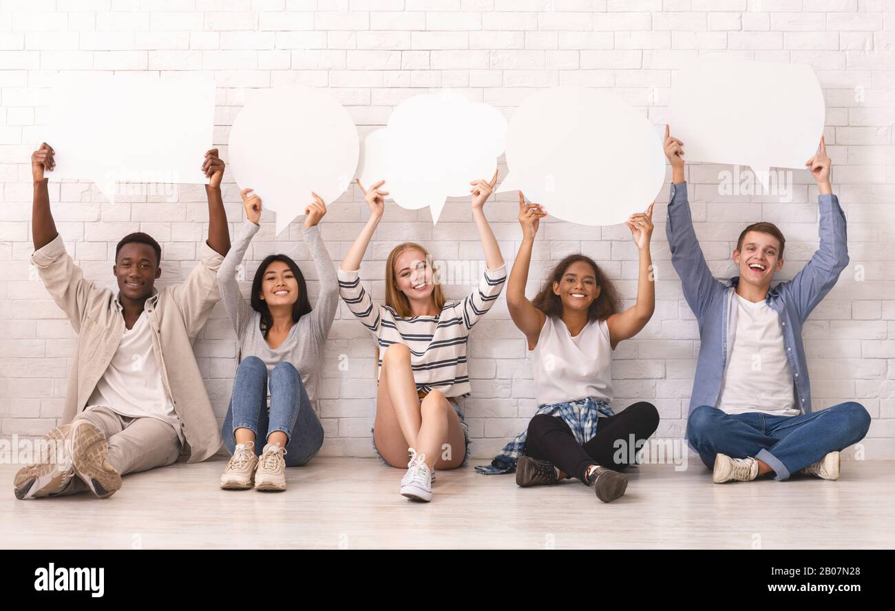 Joyful group of multiracial friends holding communication bubbles Stock ...