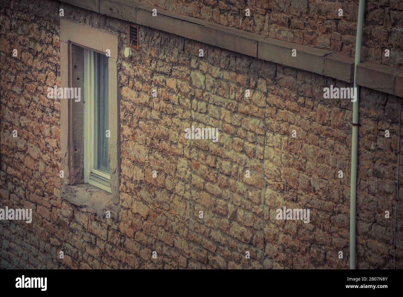 Small window at an old sandstone facade Stock Photo - Alamy