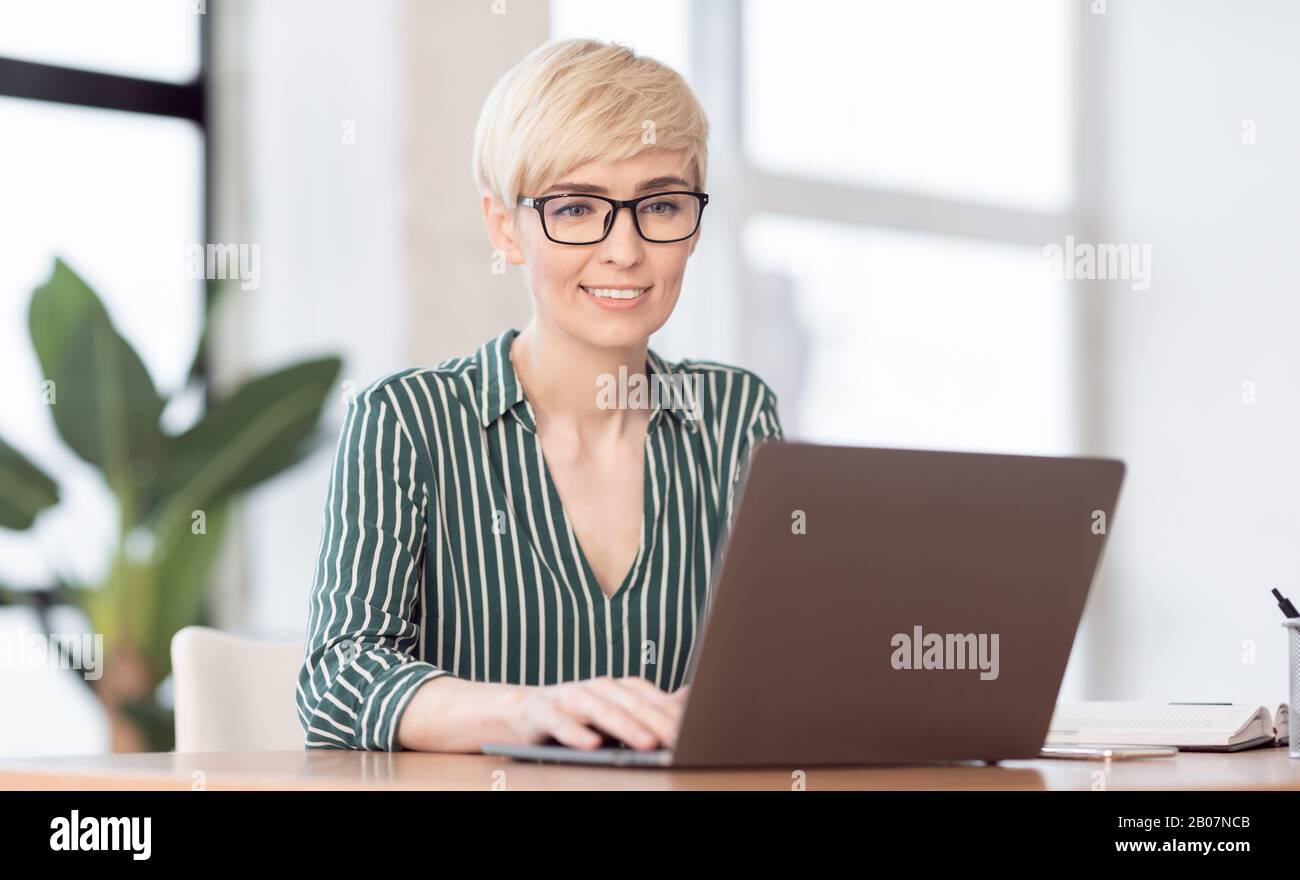 Lady Working On Laptop Typing Business Report Sitting In Office Stock ...
