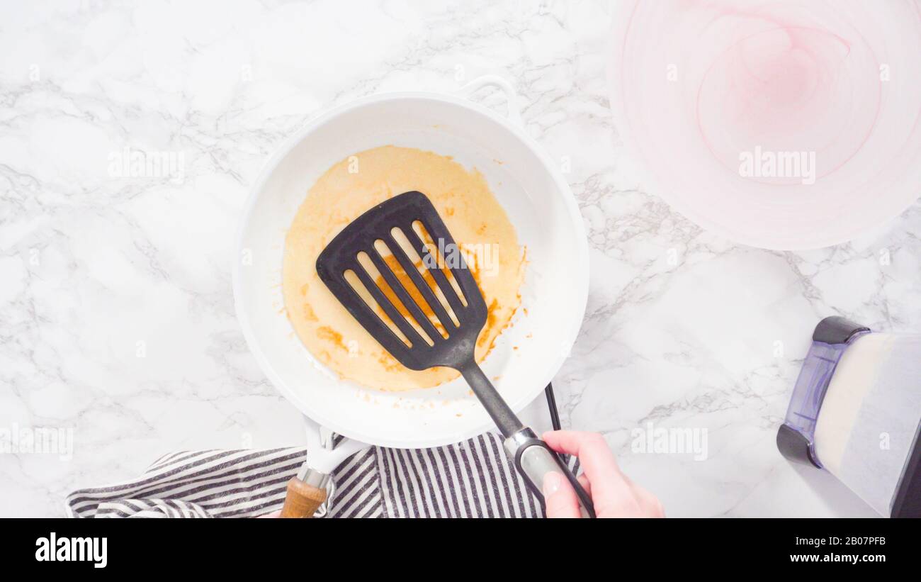 Flat lay. Making crepes in a small frying pan over medium heat Stock ...
