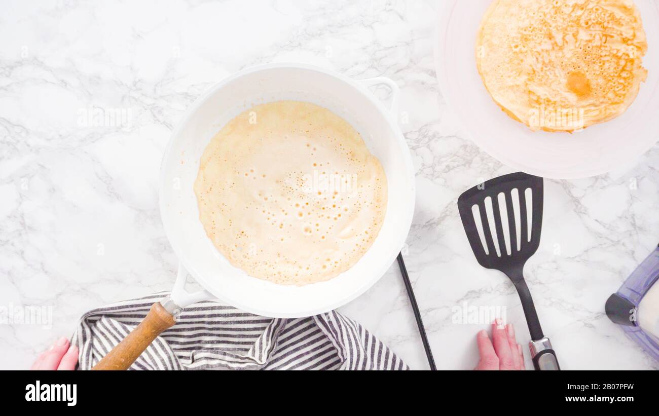 Flat lay. Making crepes in a small frying pan over medium heat Stock ...