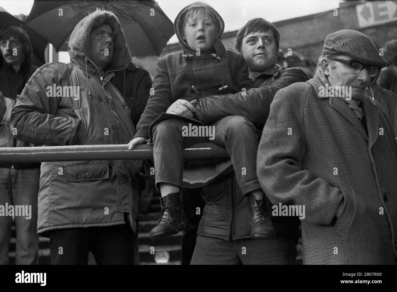 Football Working Class family group. Father holding young son taking ...
