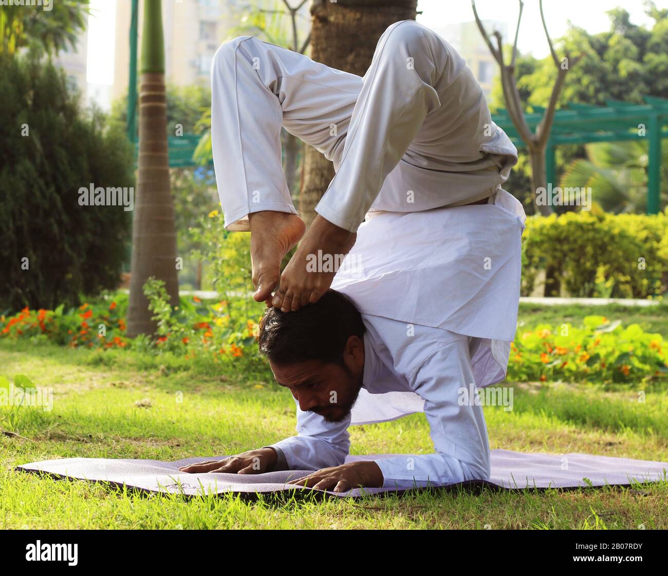 Indian Yoga Asana - An Indian Yoga instructor showing Yoga asana Stock ...