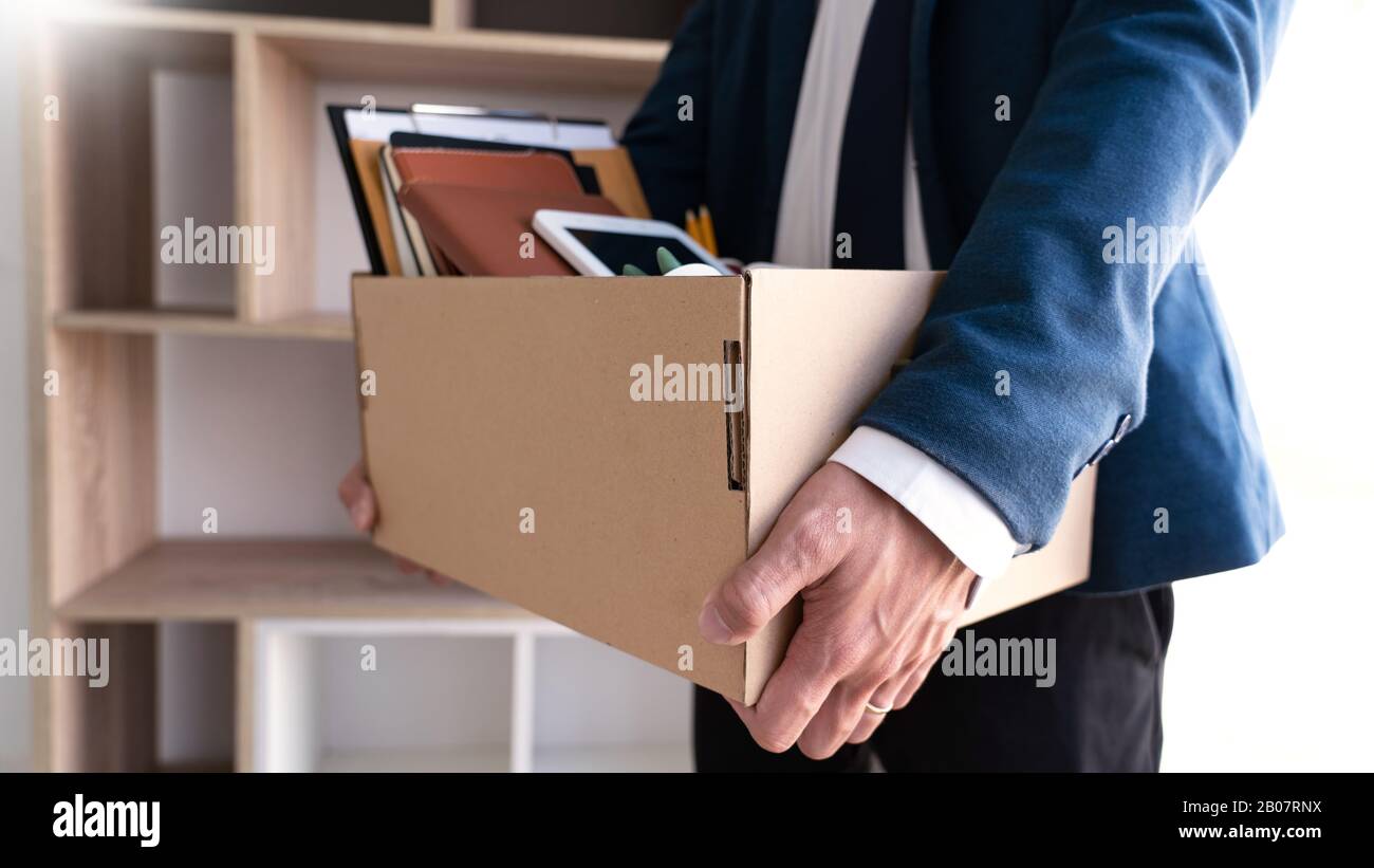 Businessmen are holding resignation document and packing personal ...