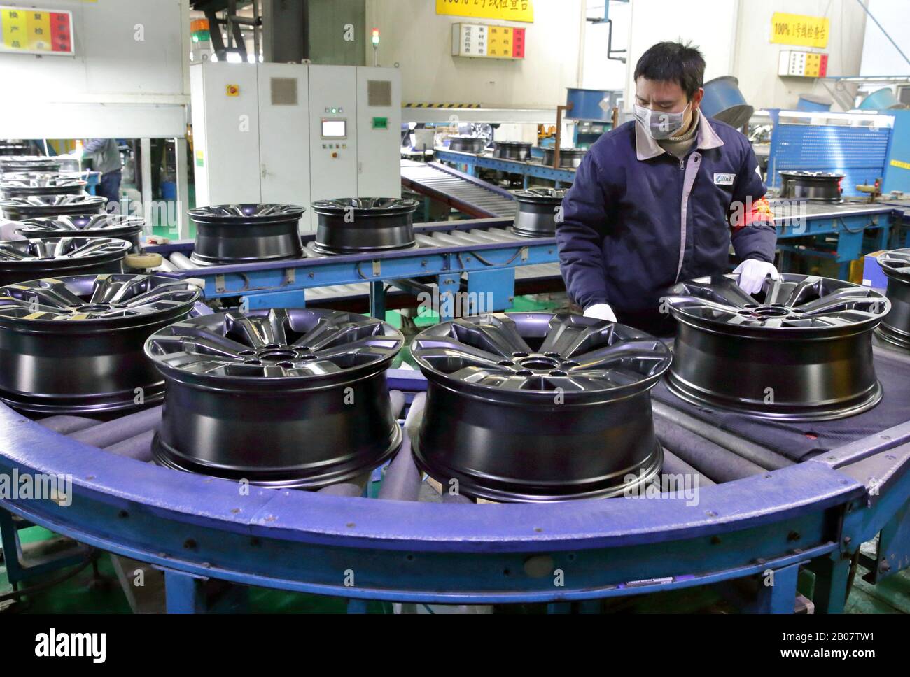Chinese workers manufacture aluminium-alloy car rims at the plant of ...