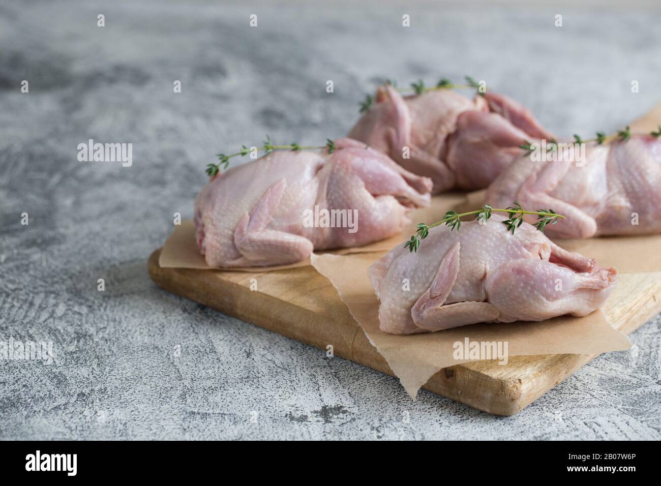 Raw uncooked quail. raw meat quails ready for cooking on a cutting ...