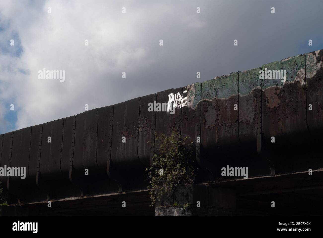 graffiti on a railway bridge at dusk Stock Photo - Alamy