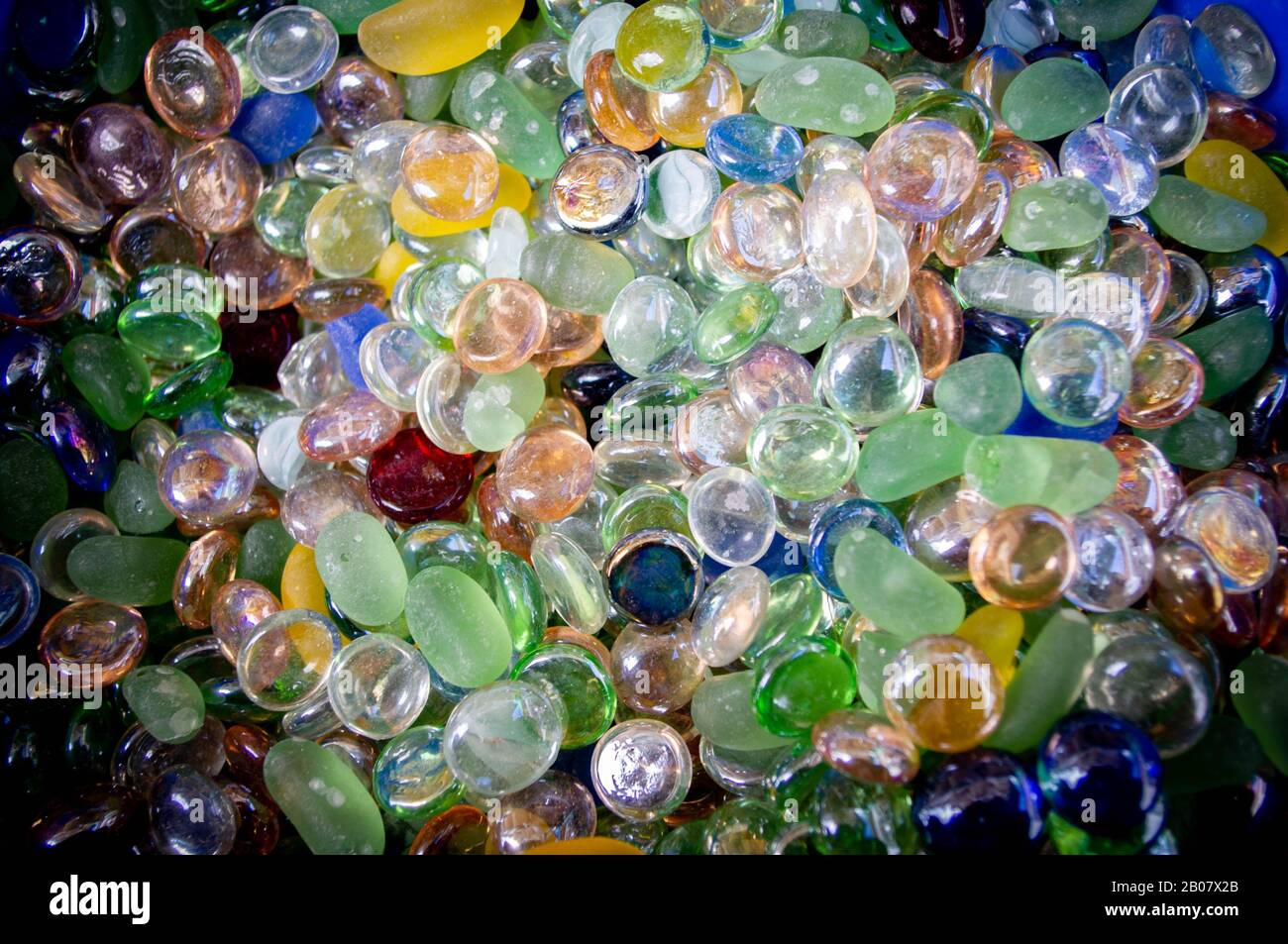 coloured glass gems and rock background Stock Photo - Alamy