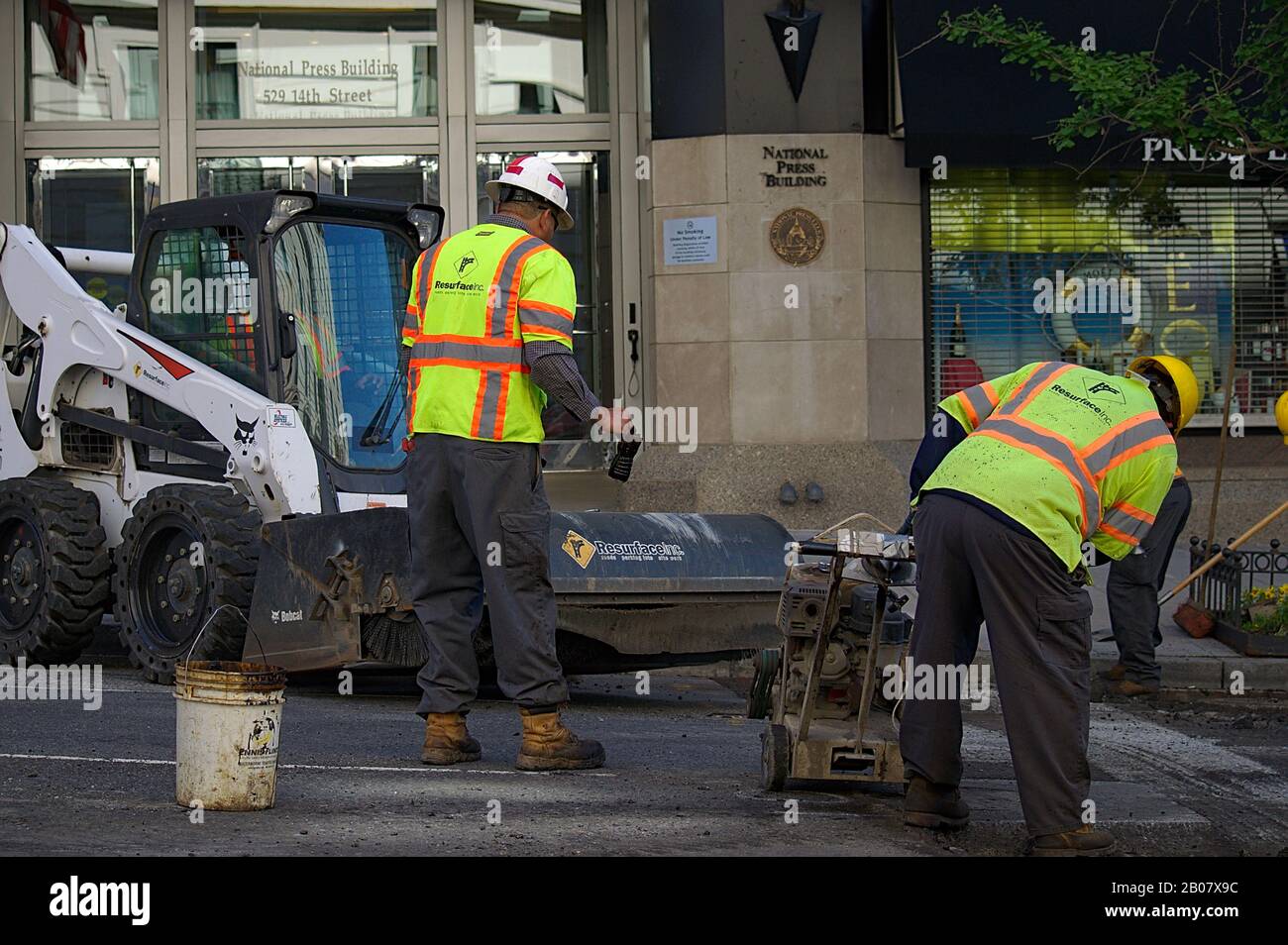 Public work workers working on Washington DC street in yellow vests and ...