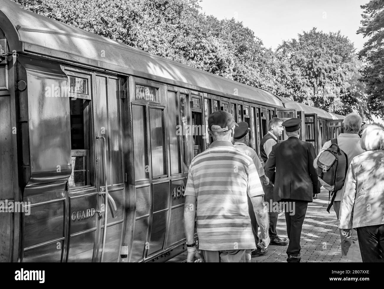 10 Passengers boarding the traditional wooden train carriage at Holt ...