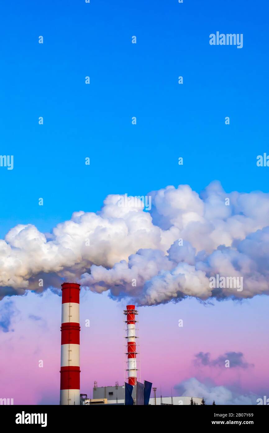 Chimneys with factory fumes at sunset hi-res stock photography and ...