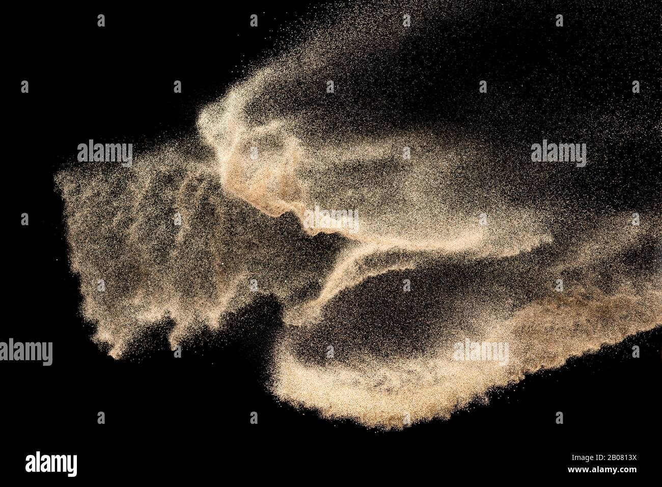Brown colored sand splash.Dry river sand explosion isolated on black ...