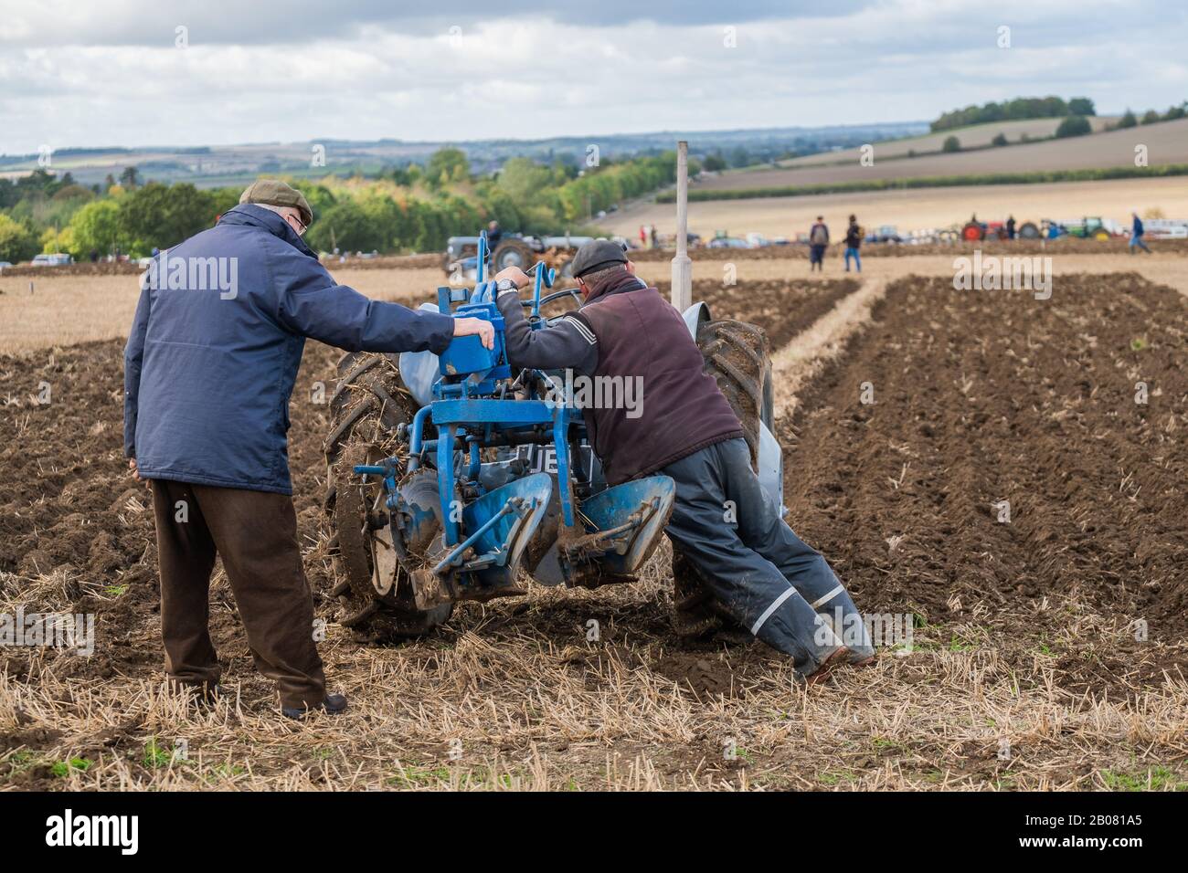 Farmers fixing the plough Stock Photo - Alamy