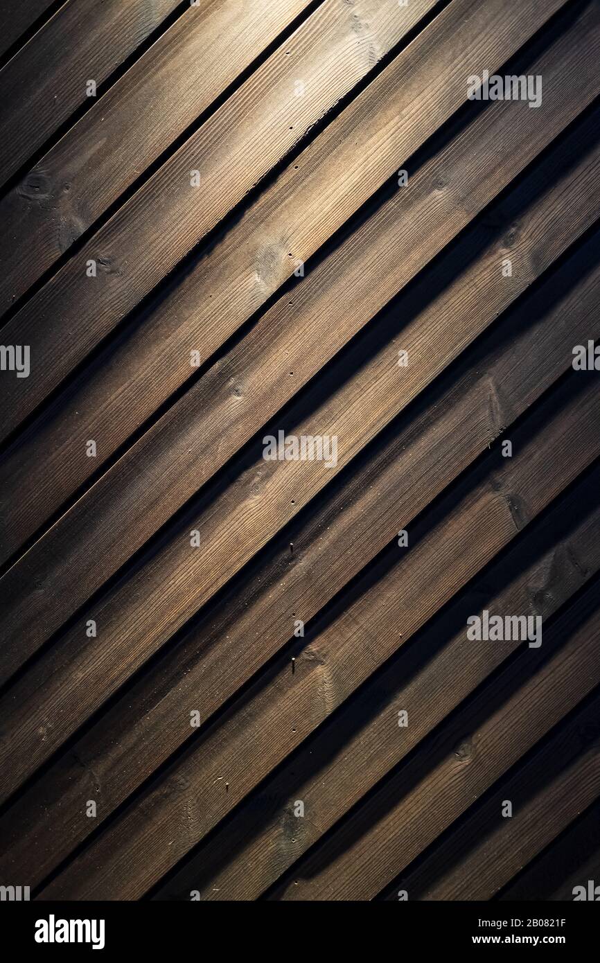 Wooden wall with a spot of light from above. Can be used as background ...