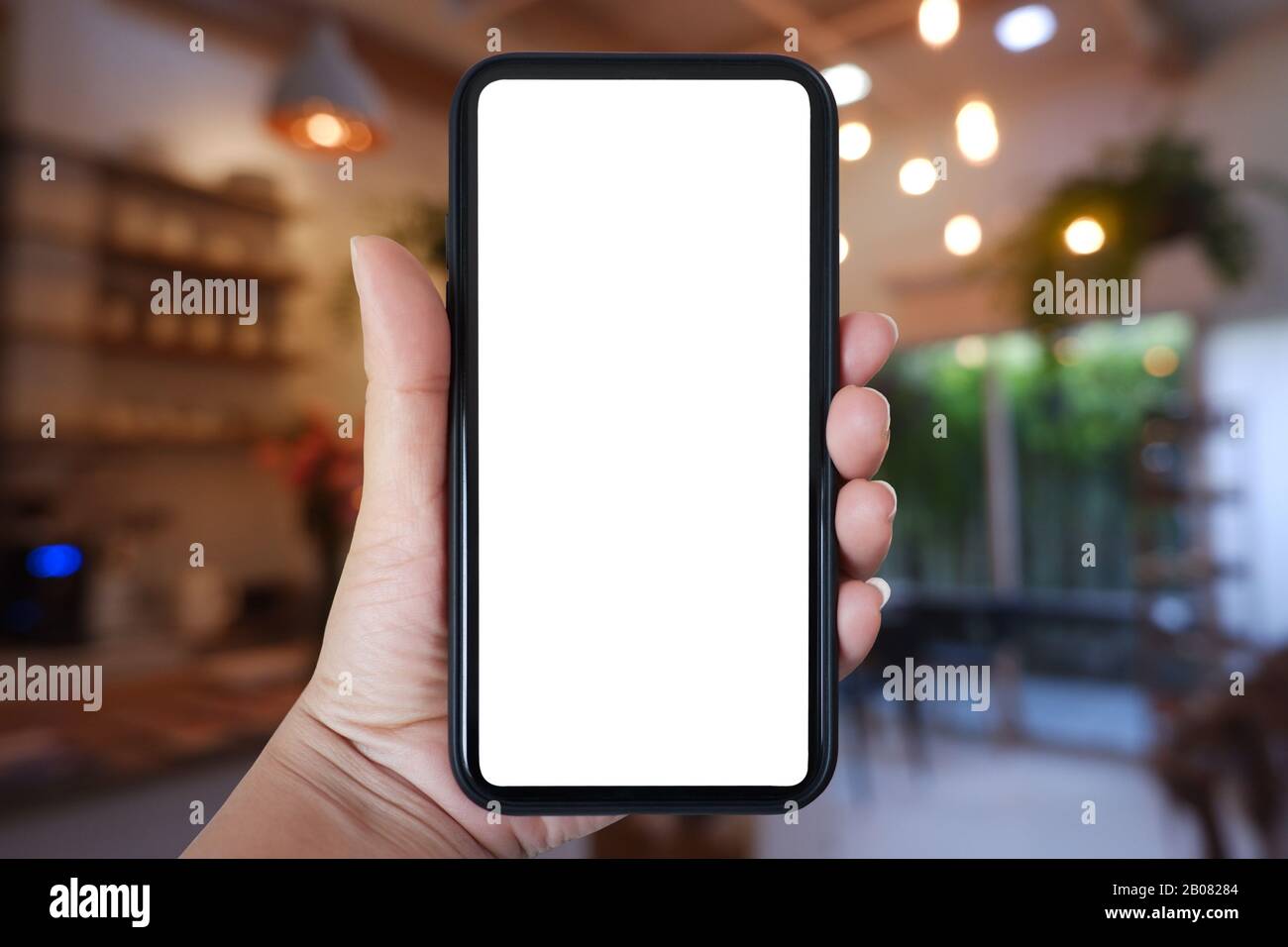 Close-up hand holding phone vertical, Using smart phone with blurred ...
