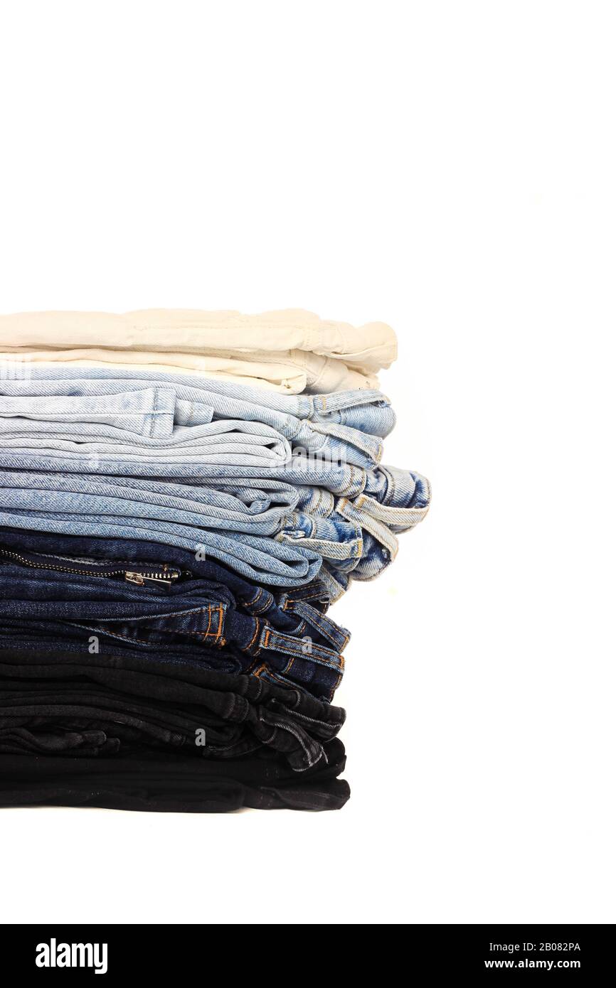 folded stack of blue jeans gradient, white backdrop high key studio ...