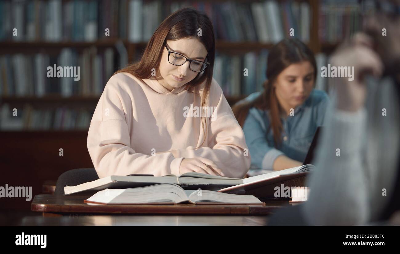 Girl studying in library Stock Photo - Alamy