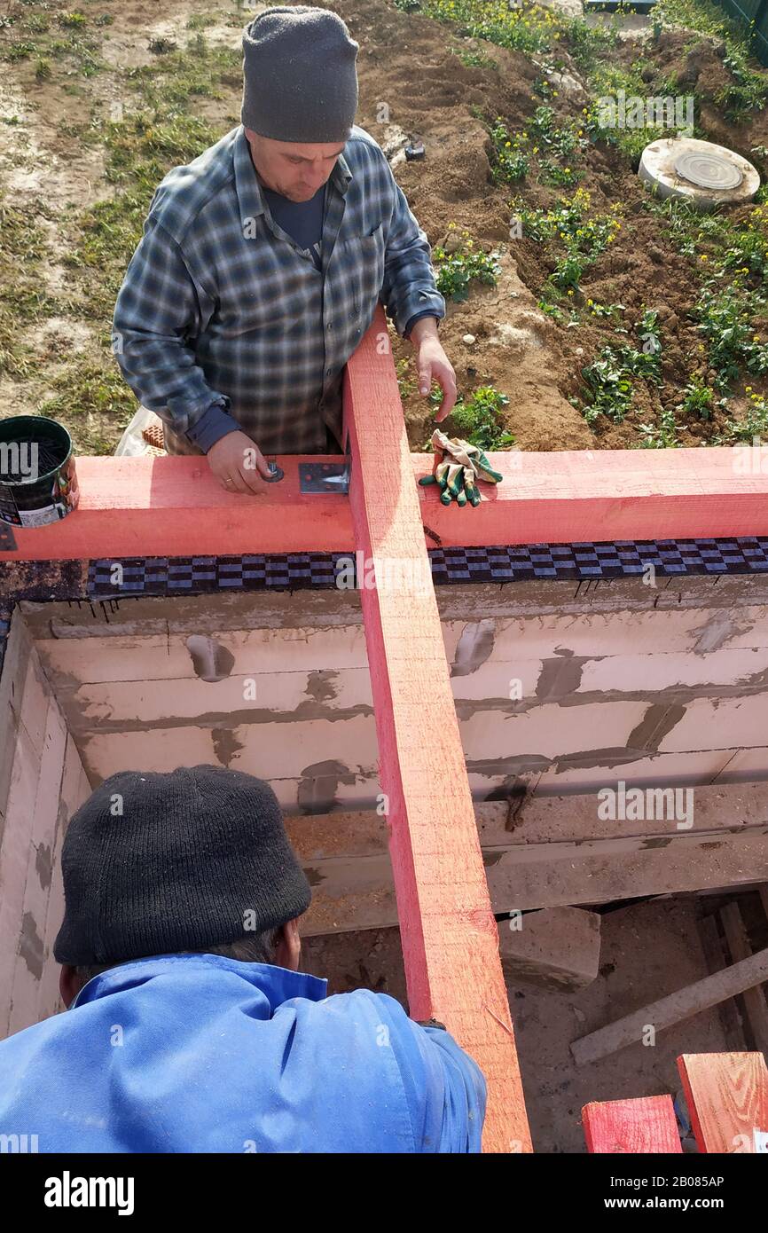 Installation of wooden beams in the construction of the roof system of ...