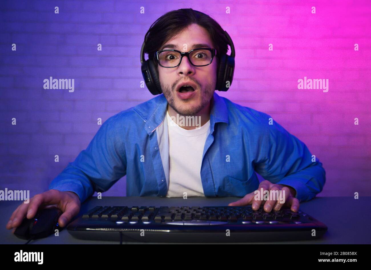 Amazed Guy Playing Computer Game Online Sitting At Home Stock Photo - Alamy