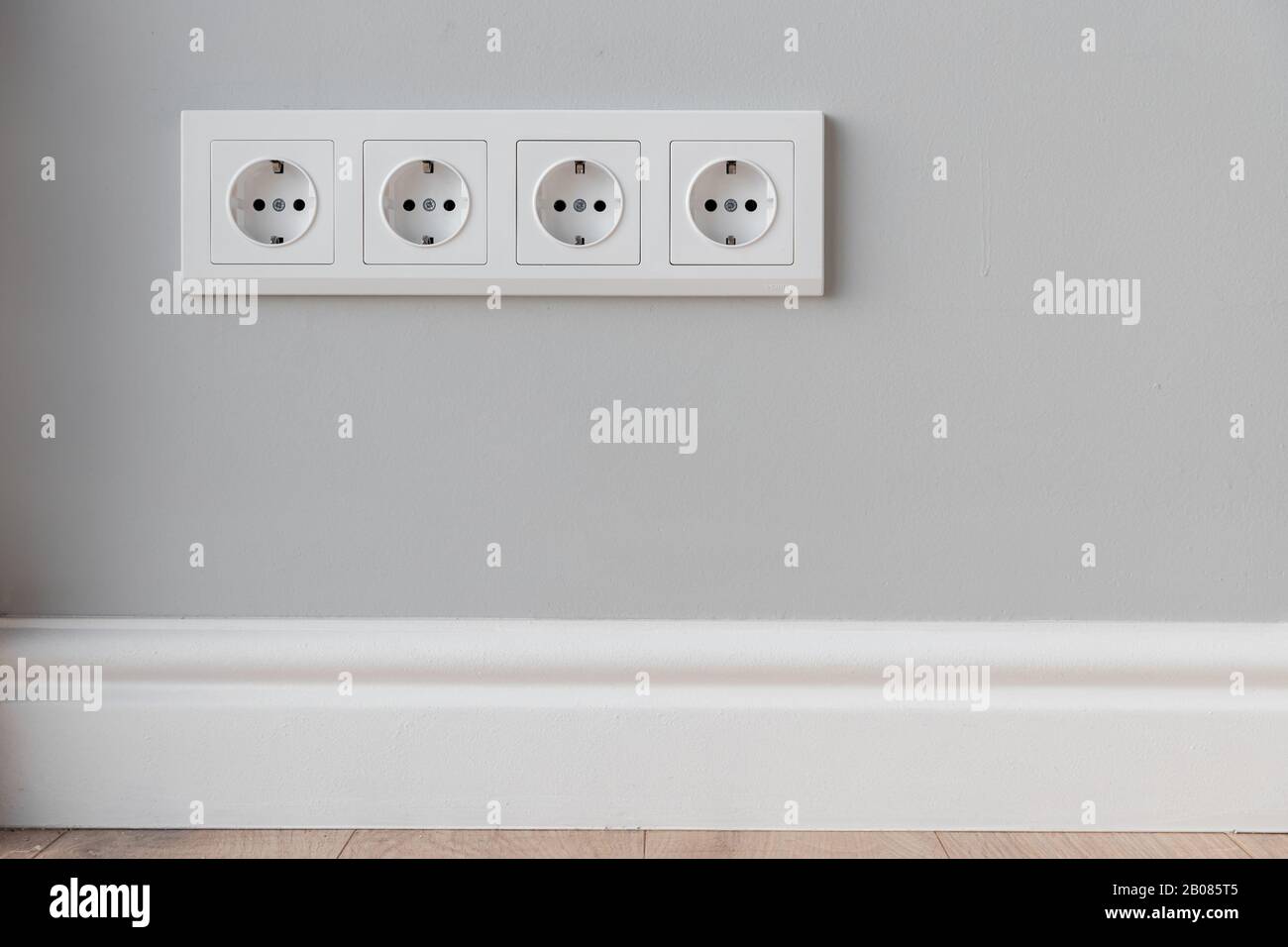 White European sockets on gray concrete wall in loft style, with high ...