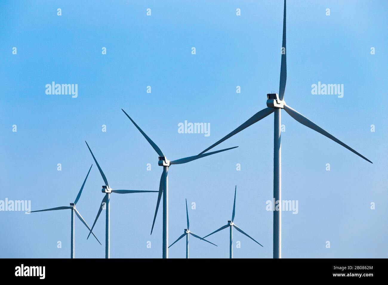 Large wind turbines moving to create kinetic energy for renewable ...