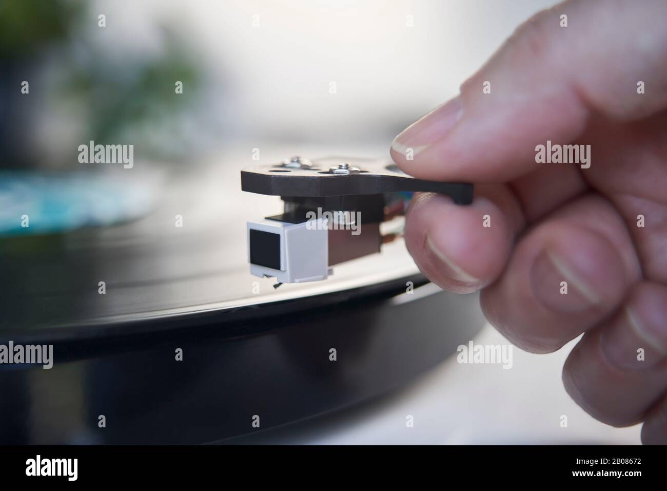 Close Up Of Hand Putting Needle Of Record Player Turntable On Vinyl LP ...