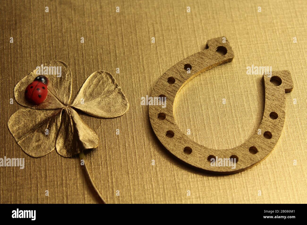 The picture shows luck symbols on a golden background Stock Photo - Alamy