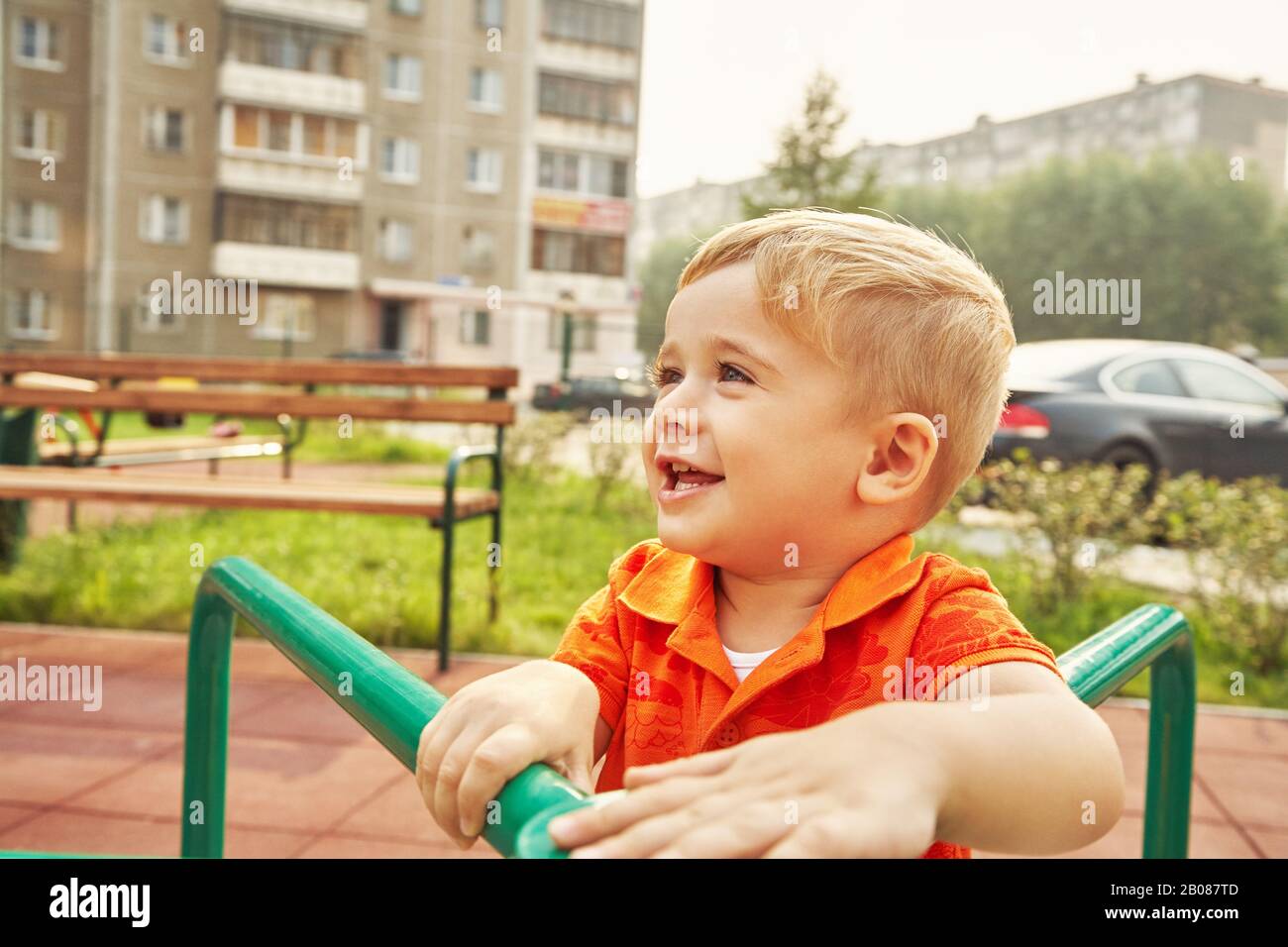 Active little boy on playground. playing child on merry go round Stock ...
