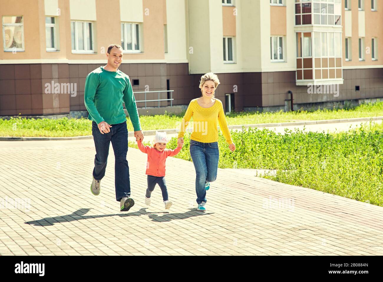 happy playing family outdoors. young parents with a baby for a walk in ...