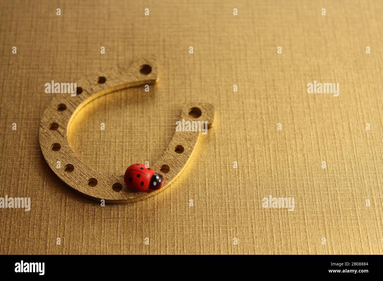 The picture shows luck symbols on a golden background Stock Photo - Alamy