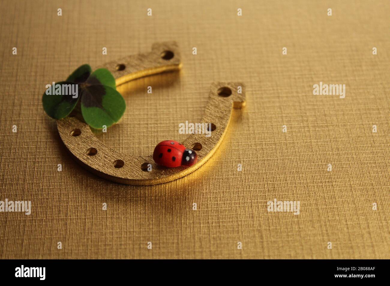 The picture shows luck symbols on a golden background Stock Photo - Alamy