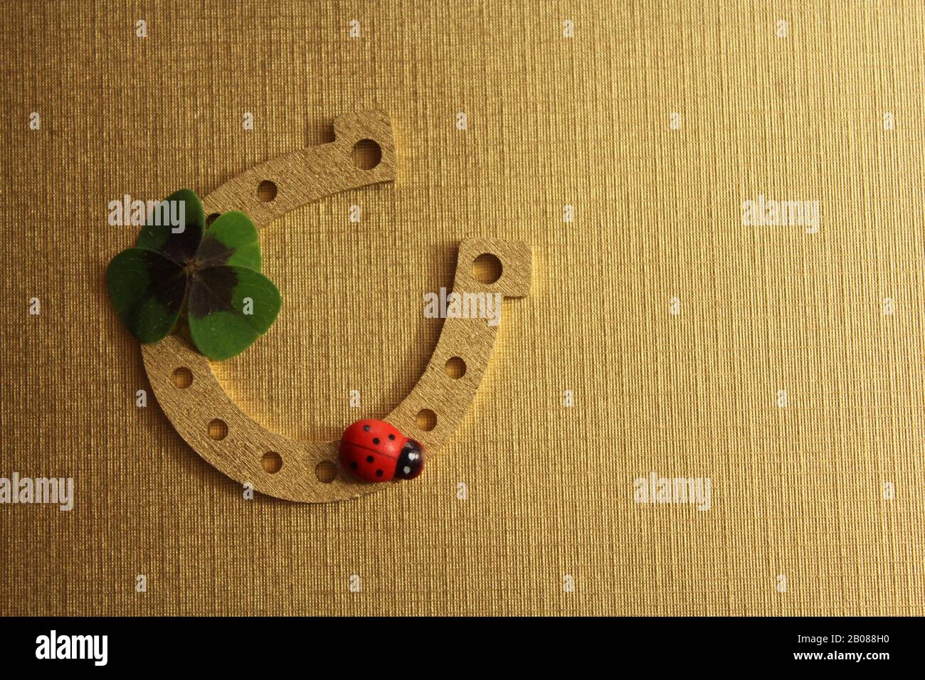 The picture shows luck symbols on a golden background Stock Photo - Alamy