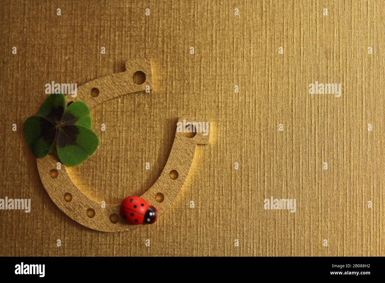 The picture shows luck symbols on a golden background Stock Photo - Alamy