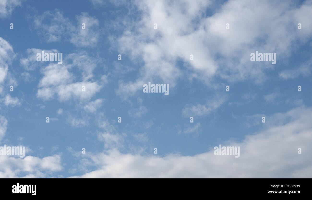 blue sky with clouds useful as a background Stock Photo - Alamy