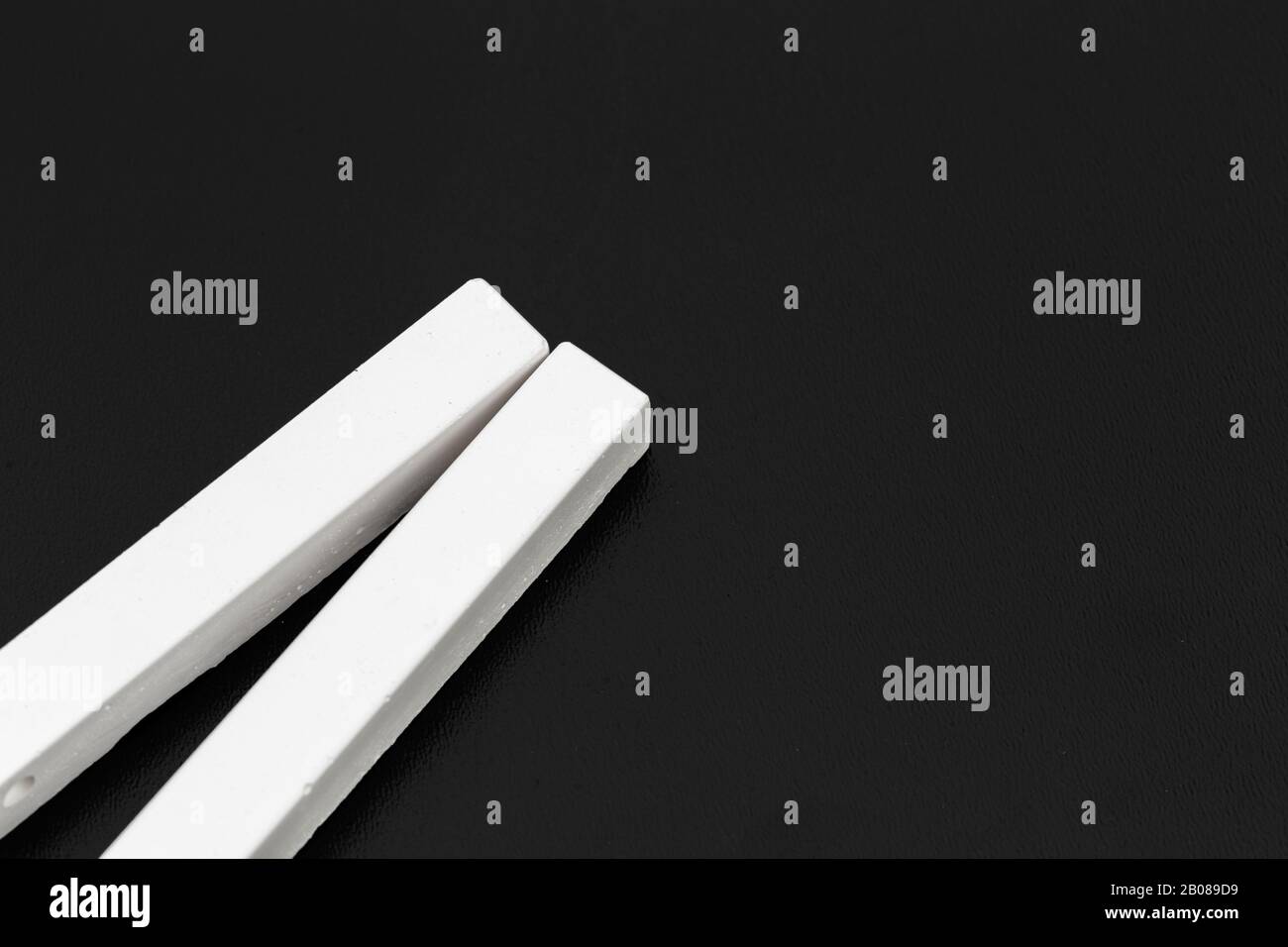 pieces of white chalk photographed over a blackboard Stock Photo - Alamy