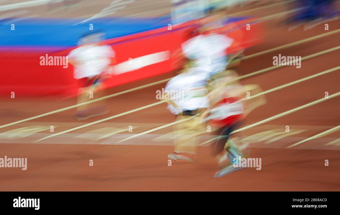Athletes running on sport stadium blur motion Stock Photo - Alamy