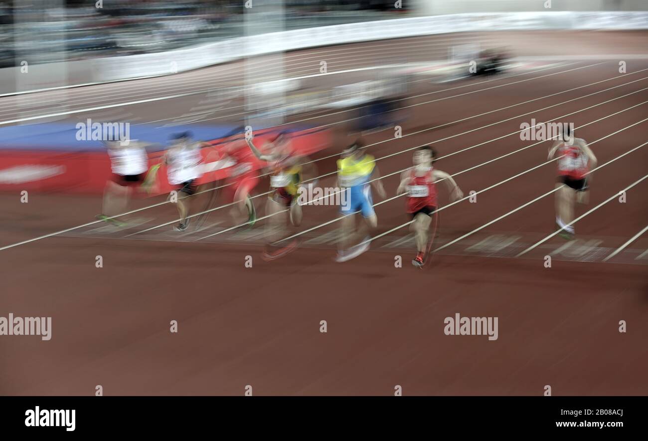 Athletes running on sport stadium blur motion Stock Photo - Alamy