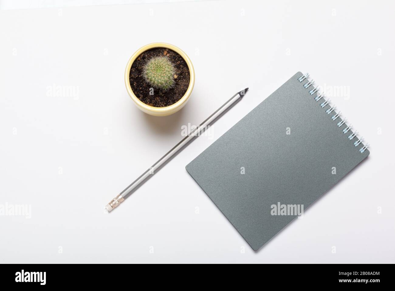 Grey notepad and pencil on working table top view Stock Photo - Alamy