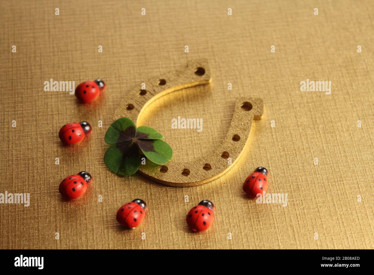The picture shows luck symbols on a golden background Stock Photo - Alamy