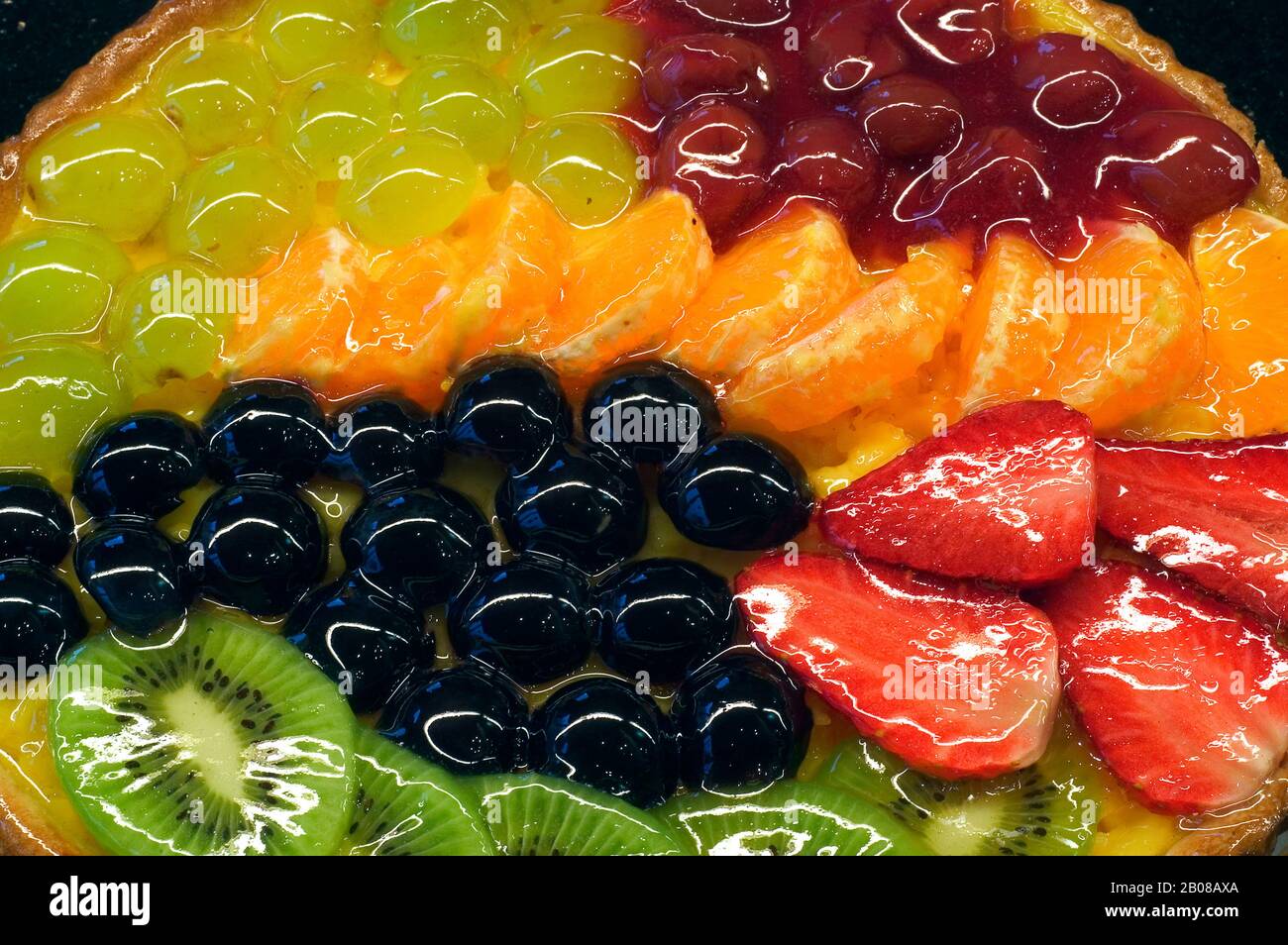 Colourful fruit tart on display in pastry shop / bakery Stock Photo - Alamy
