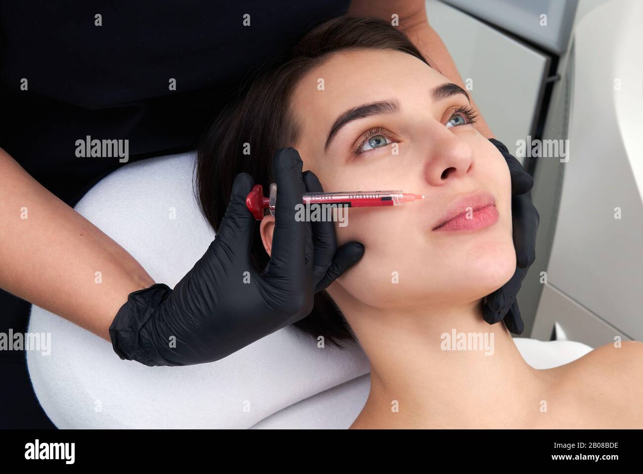 Beautiful woman gets an injection in lips Stock Photo - Alamy