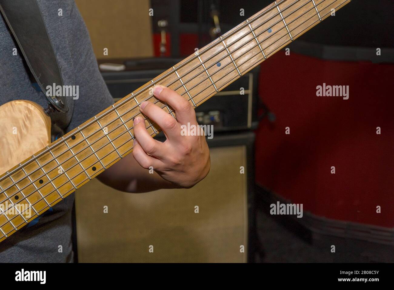 The bass player plays a five-string bass guitar close-up. Plays bass ...