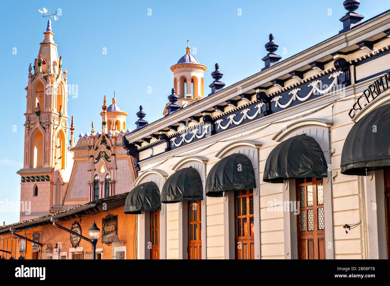 Ornate colonial style buildings and the bell tower of the Church of Our ...