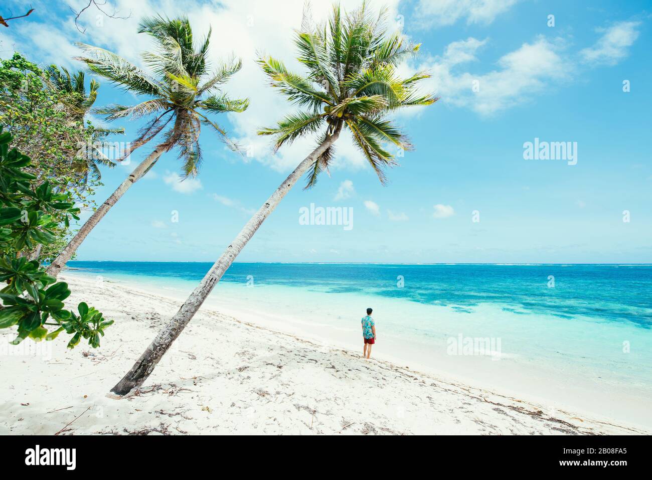 Man standing on the beach and enjoying the tropical place with a view ...