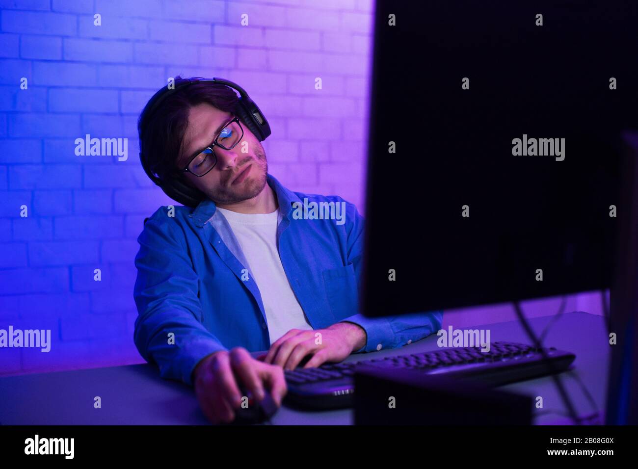 Gamer Sleeping At Desktop PC Sitting At Desk Indoor, Low-Light Stock ...
