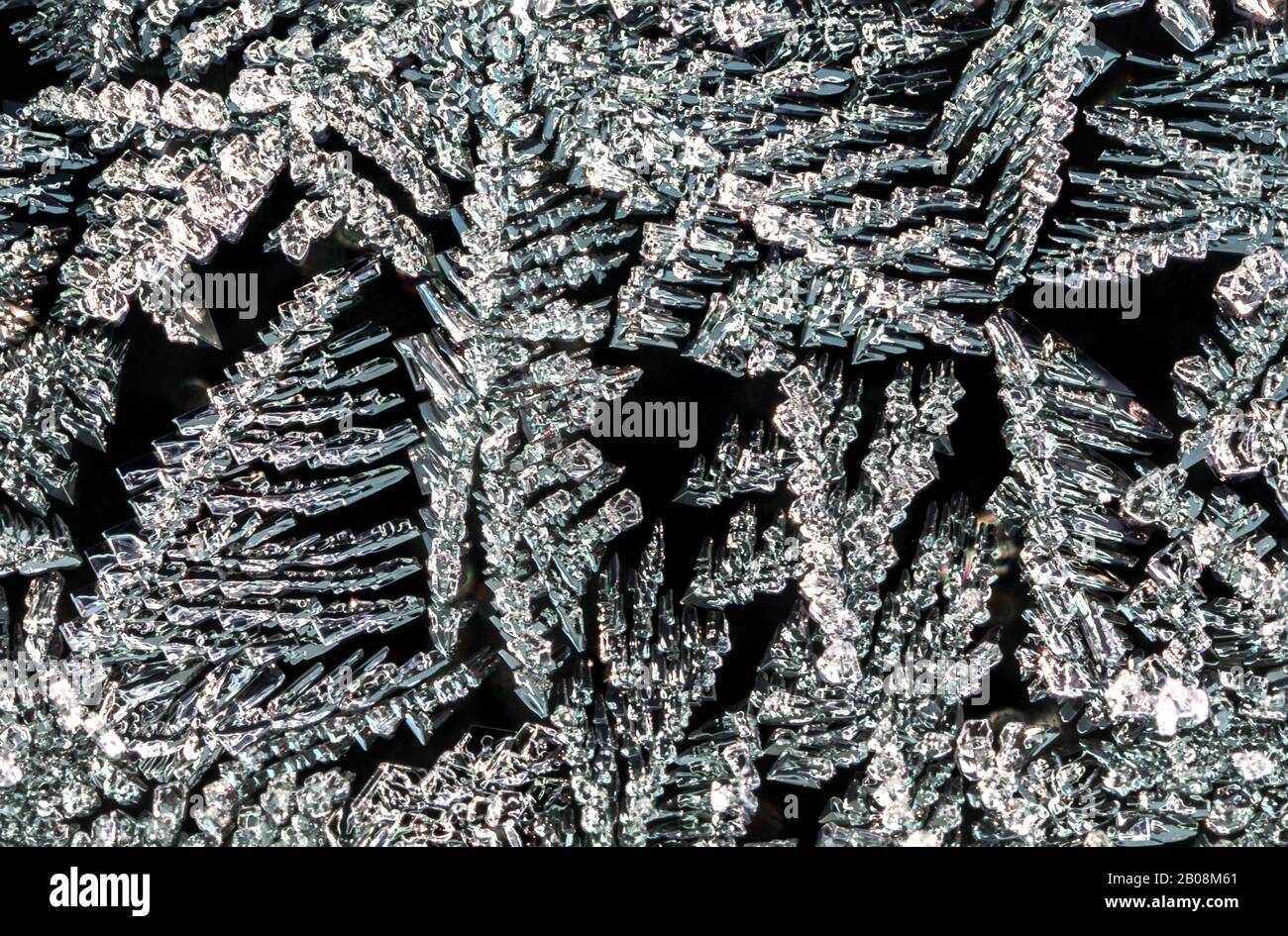 pattern of bright tiny ice crystals on black background Stock Photo - Alamy