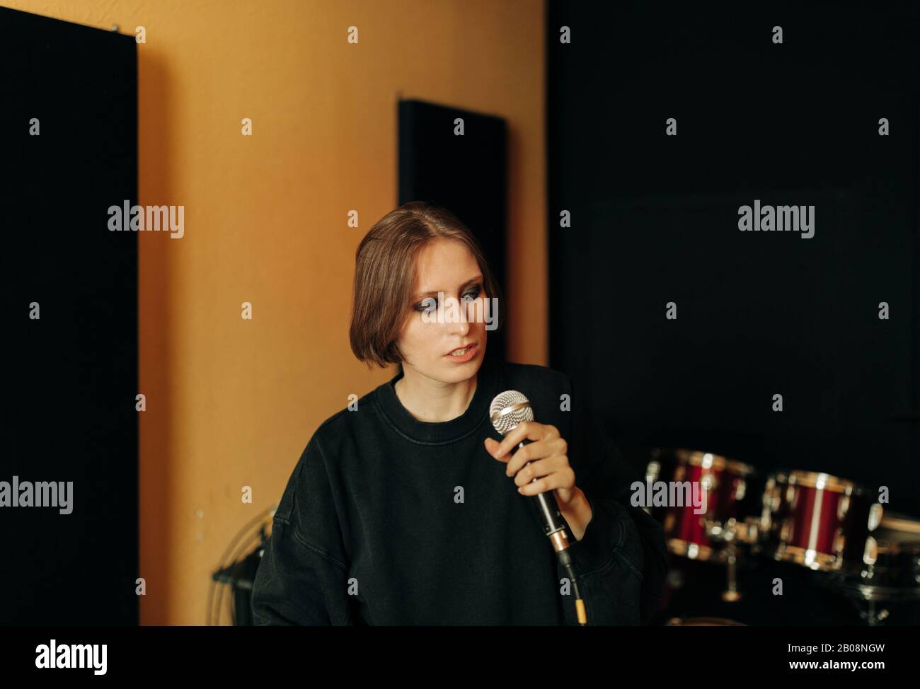 young musician with mic in recording studio Stock Photo - Alamy