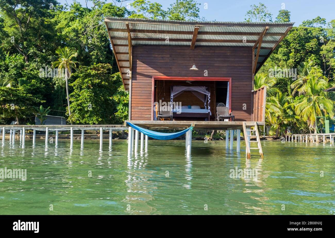 Wood Caribbean buildings over the water with boats at dock, Bocas del ...