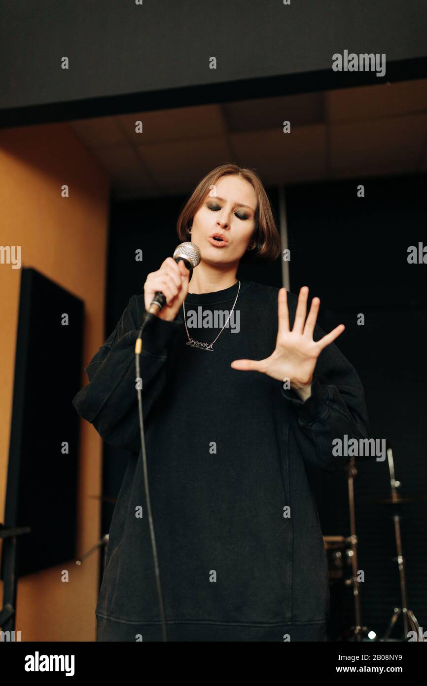 young musician with mic in recording studio Stock Photo - Alamy